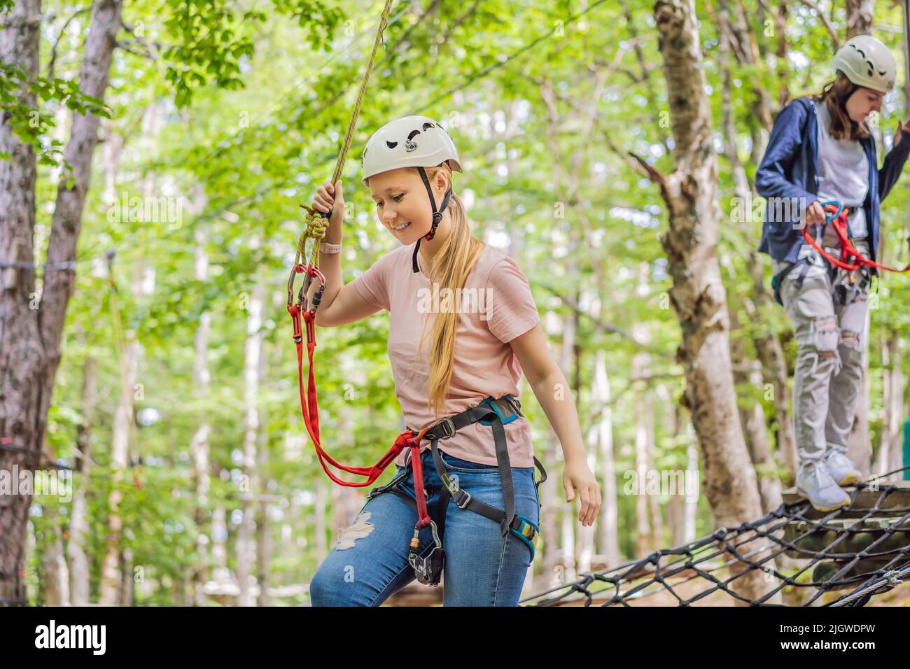 Happy women girl female gliding climbing in extreme road trolley ...