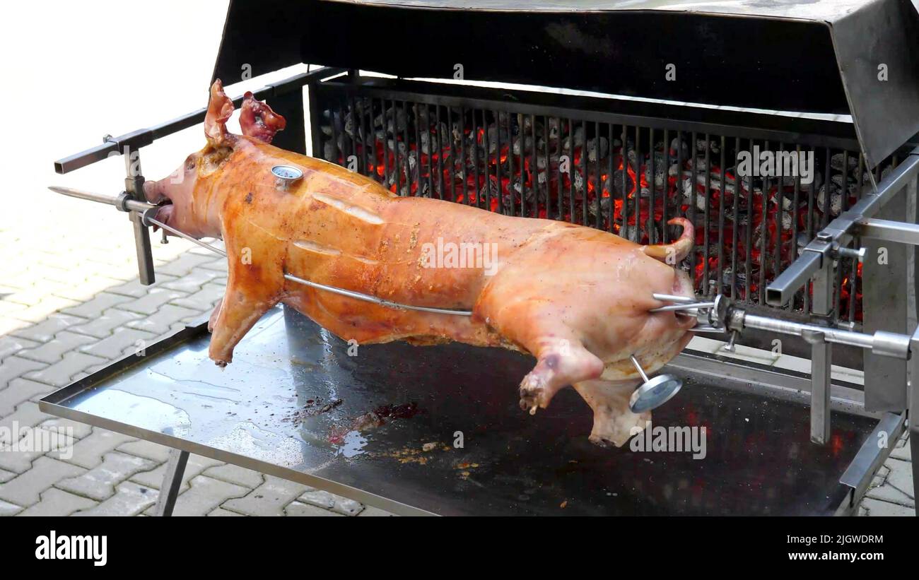 A pig roasted on a spit Stock Photo - Alamy