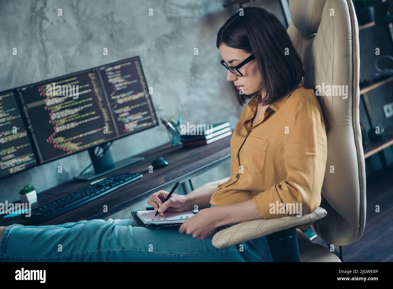 Profile side view portrait of attractive focused girl expert writing ...
