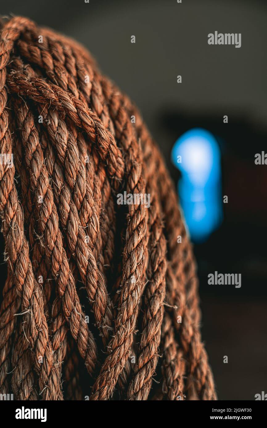 A vertical closeup of thick brown rope on blur background Stock Photo ...