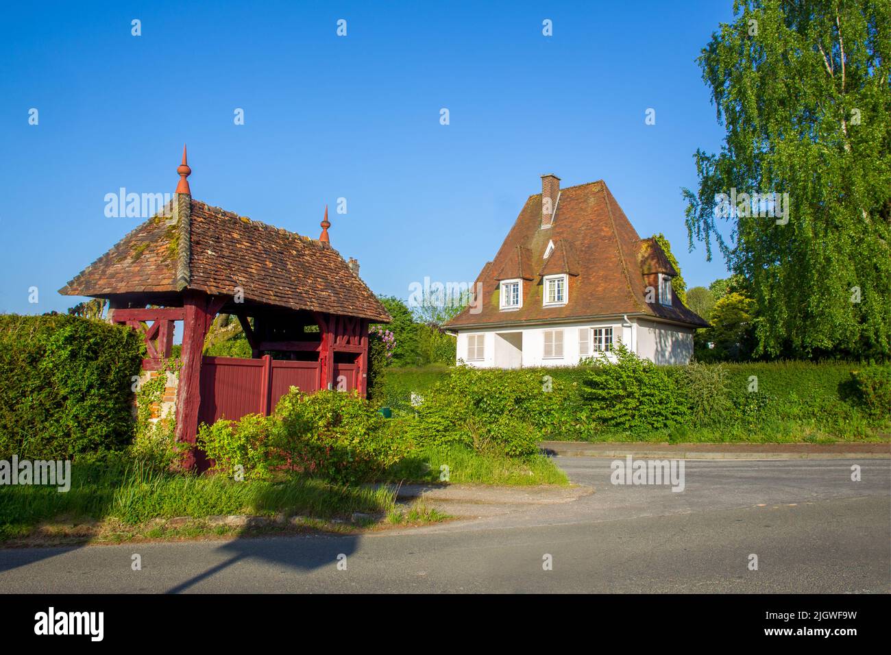 The old house in Normandy with a high tile roof and the gates of the ...