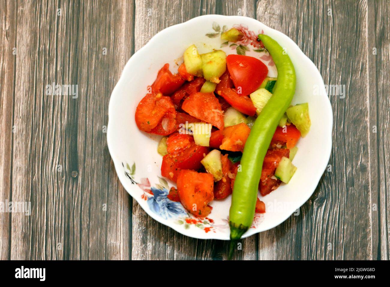 Traditional Arabic green salad with slices of cucumber and tomatoes ...