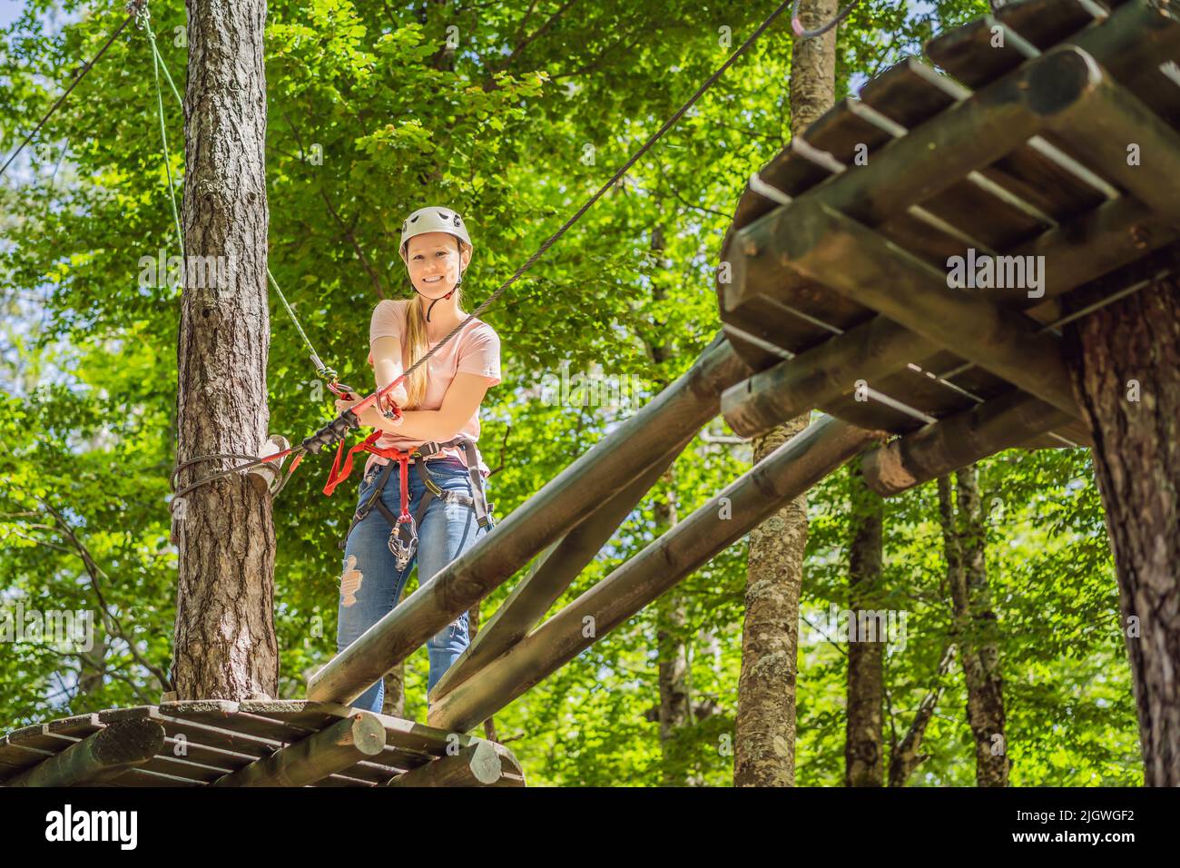 Happy women girl female gliding climbing in extreme road trolley ...