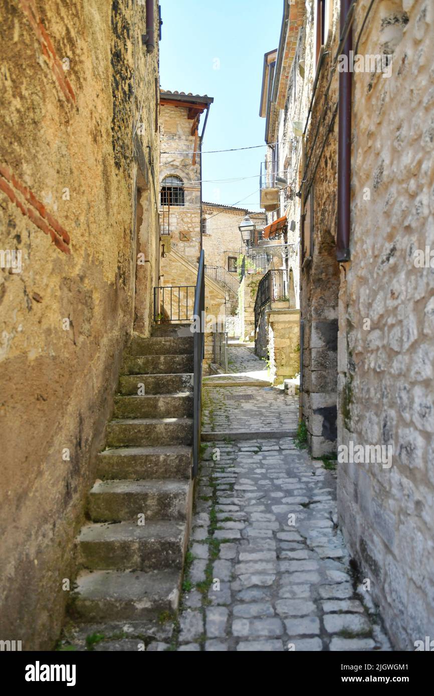 A narrow street between the old stone houses of Campo di Giove, a ...
