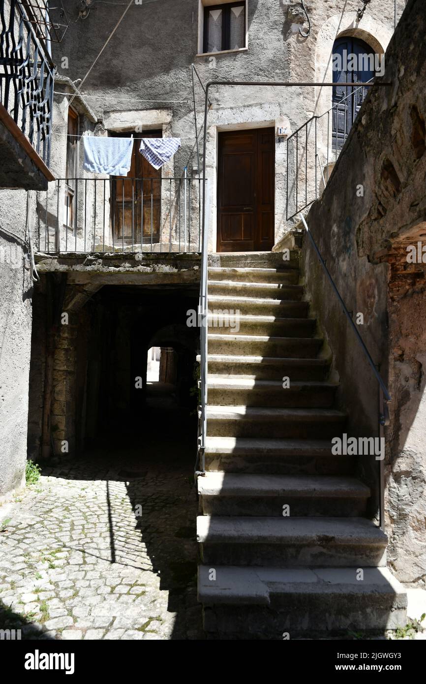 A narrow street between the old stone houses of Campo di Giove, a ...