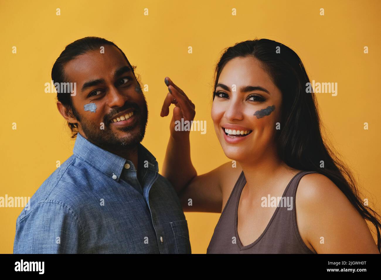 portrait of mid adult playful couple hispanic Latina woman and Indian ...