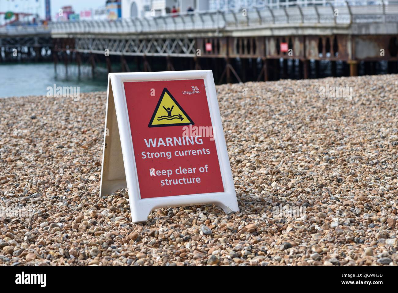 Red warning sign on a beach , warning of the danger of high currents ...