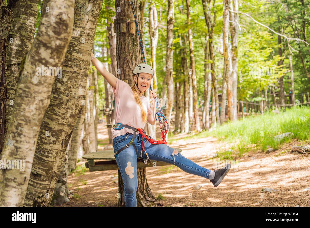 Happy women girl female gliding climbing in extreme road trolley ...