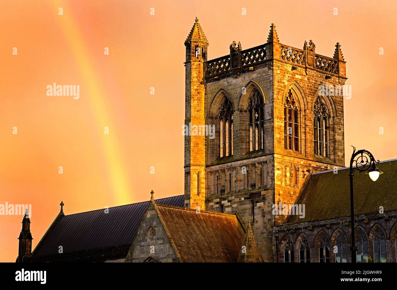 The low-angle view of a rainbow over the Paisley Abbey church Stock ...