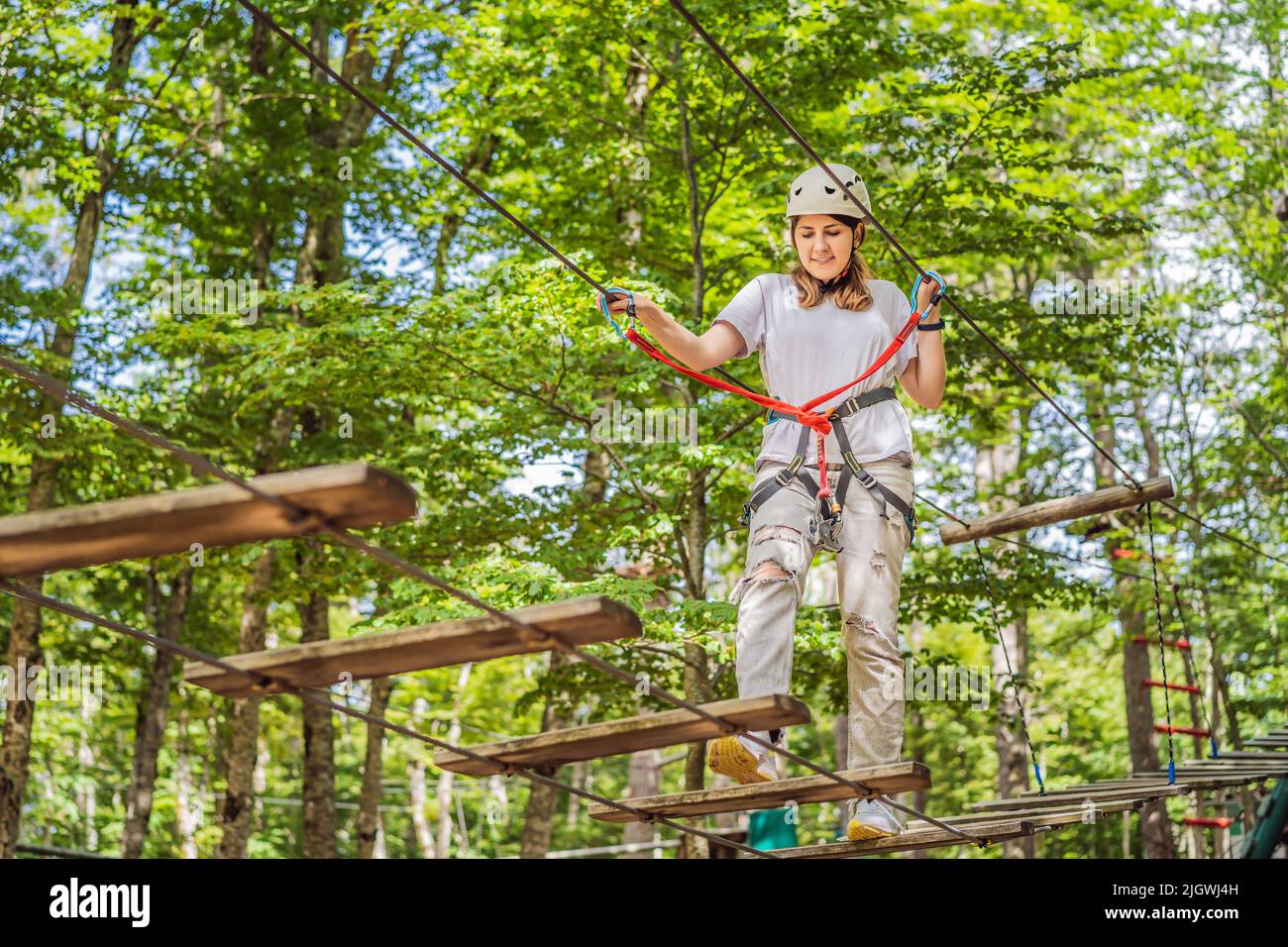 Happy women girl female gliding climbing in extreme road trolley ...