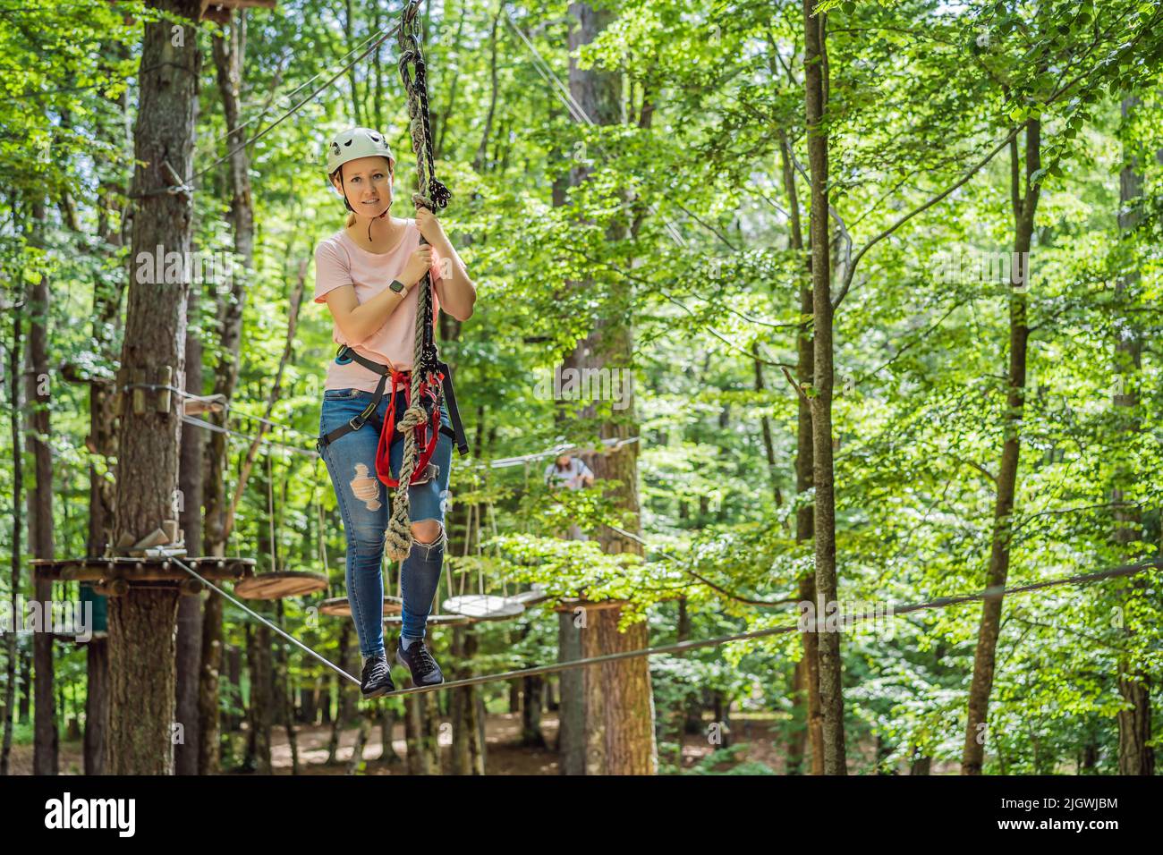 Happy women girl female gliding climbing in extreme road trolley ...