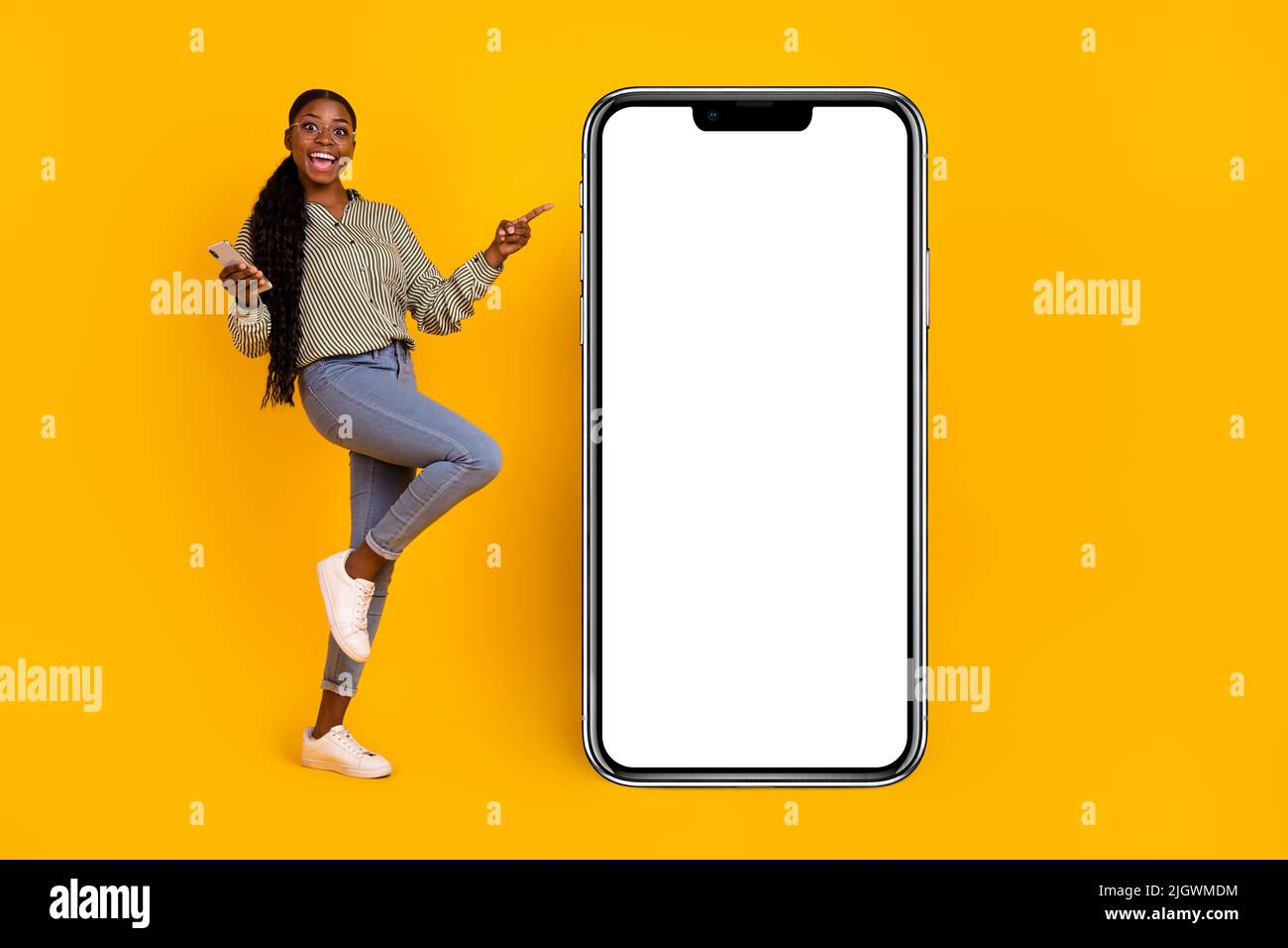 Full size photo of impressed young lady hold telephone indicate advert ...