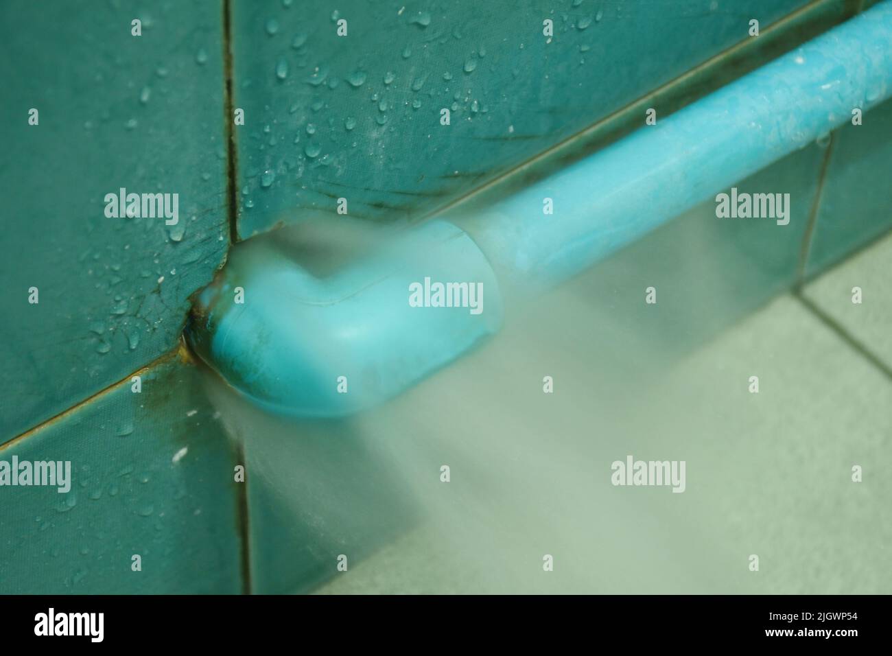 water splashing from broken plumbing blue polythene pipe line in ...
