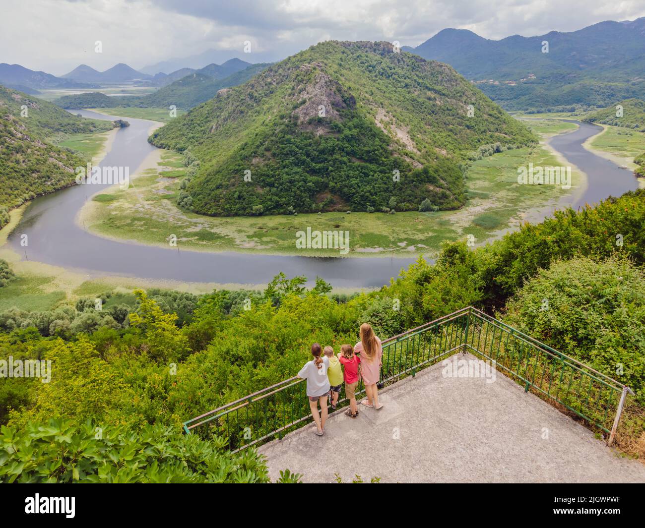 Tourists in the background Canyon of Rijeka Crnojevica river near the Skadar lake coast. One of ...