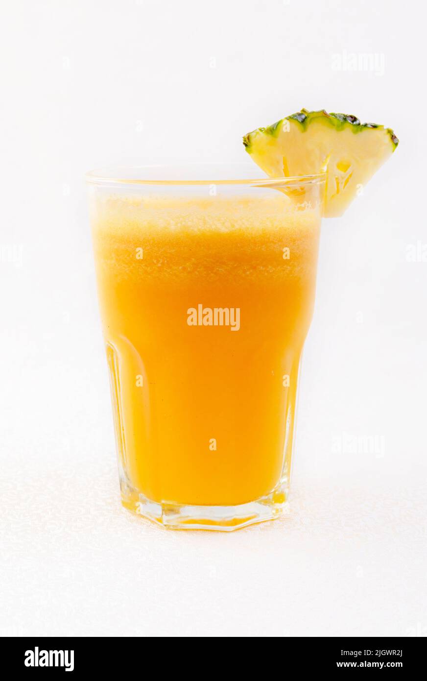 A vertical closeup of a natural juice in a cup decorated with a ...