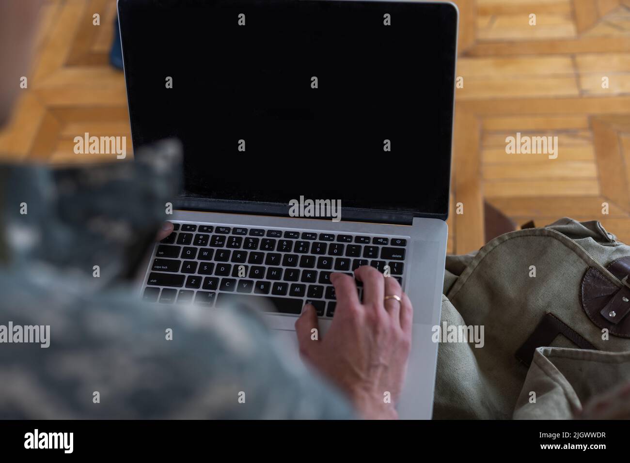 soldier in military uniform using high tech computer in headquarters ...