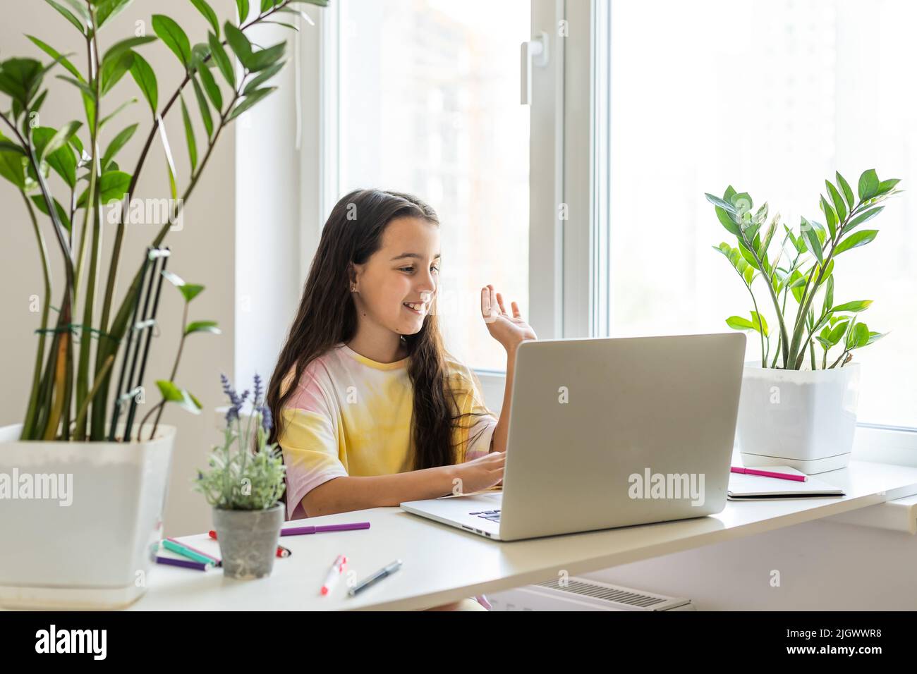 Little girl learning English indoors at online lesson Stock Photo - Alamy