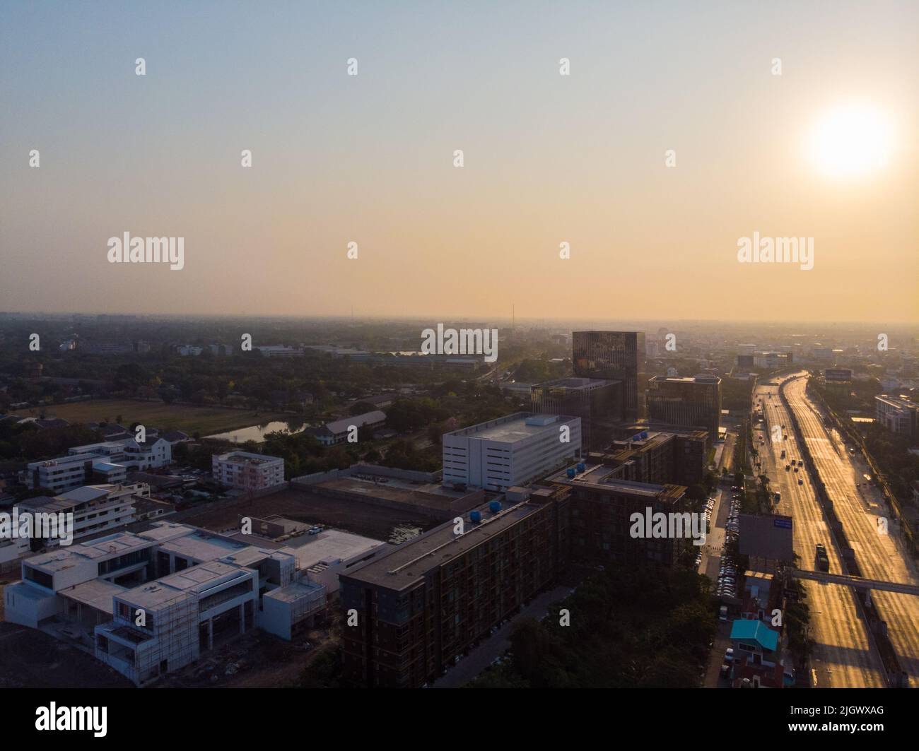 Aerial view morning sunrise city building with transport road cityscape ...