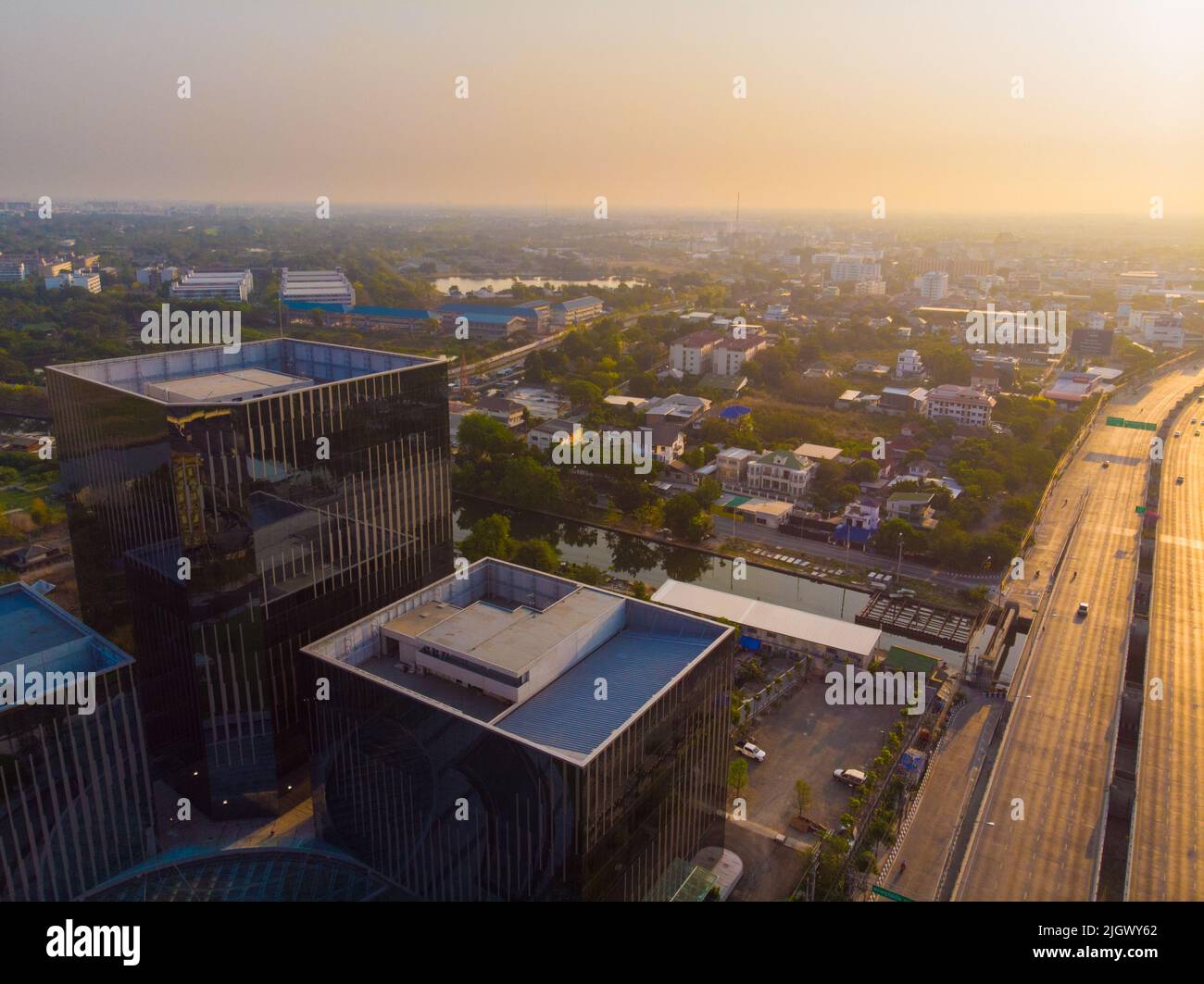 Aerial view morning sunrise city building with transport road cityscape ...