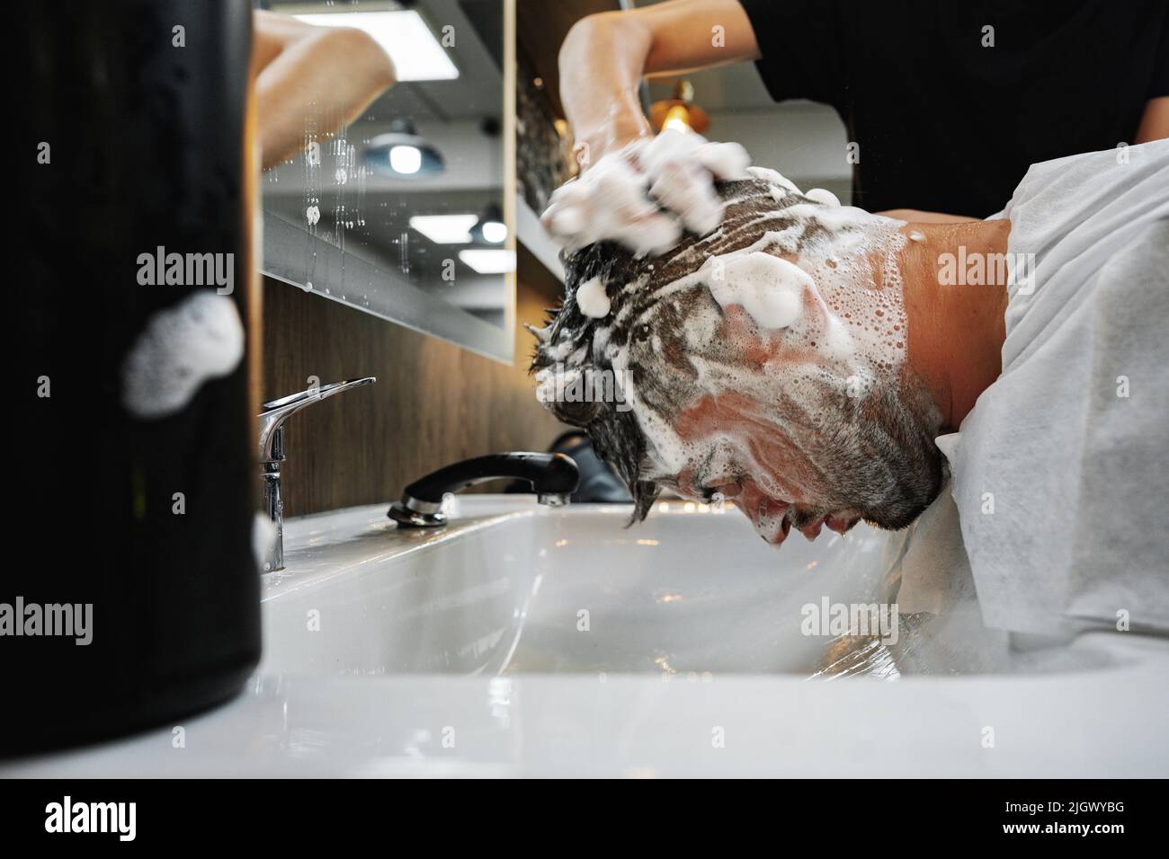 Barber shop hairdresser man washes hi-res stock photography and images - Alamy