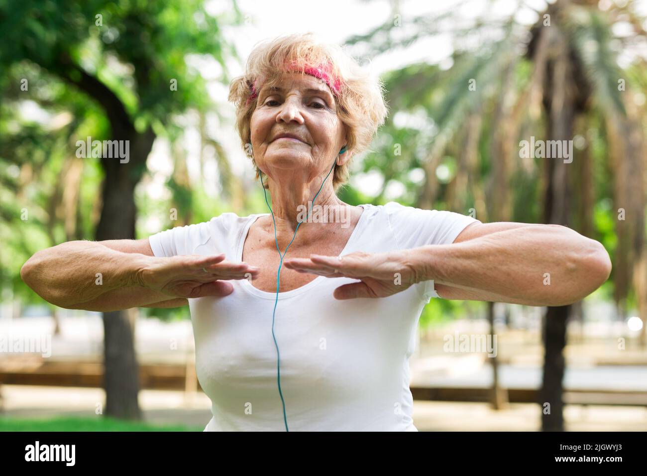 Elderly woman doing exercises at park hi-res stock photography and ...