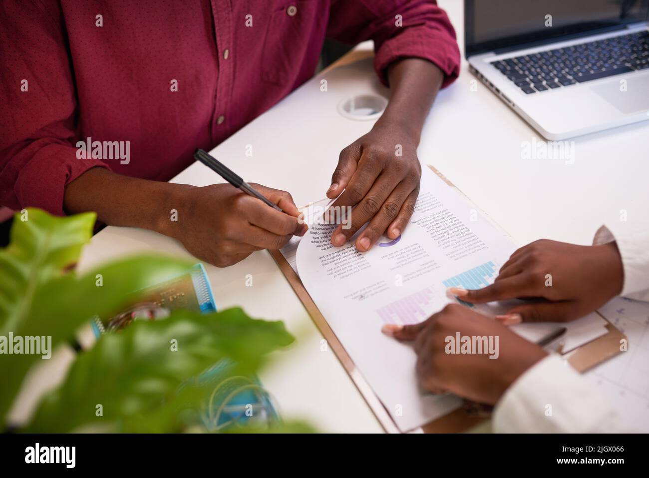 A client signs a financial statement in a meeting with advisor Stock ...