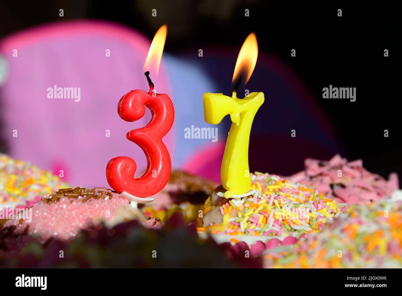 the 37th birthday lighted candles on the colorful cupcakes Stock Photo ...