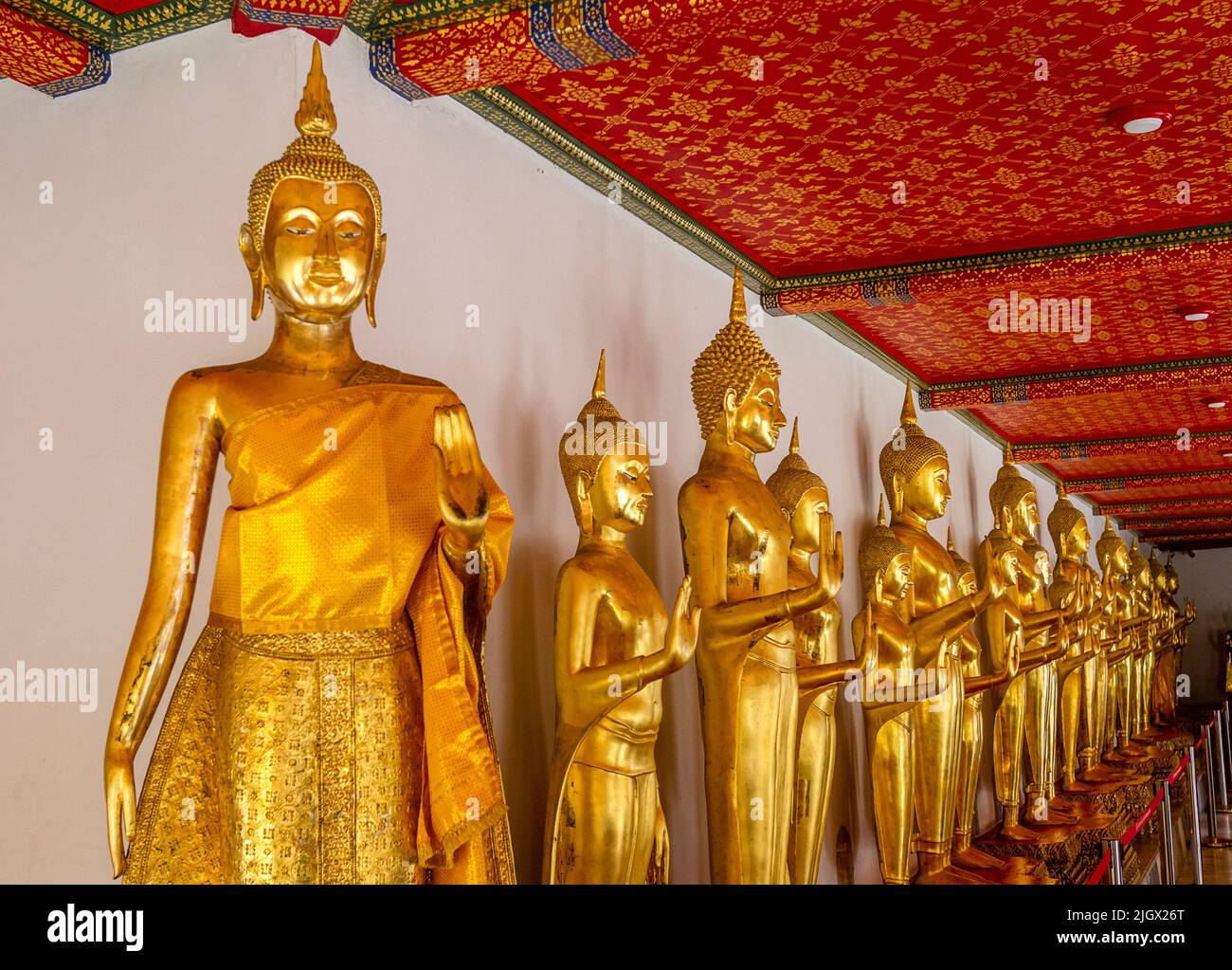 A long row of Buddha statues line the wall at Wat Pho Buddhist Temple ...