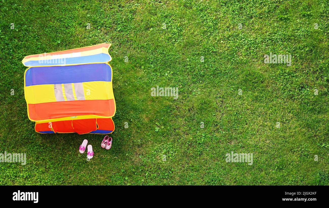 Multi-colored tent on green grass for tourism Stock Photo - Alamy