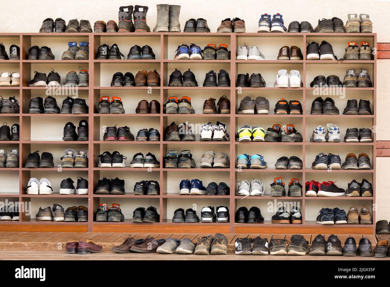 Shoes of people praying in front of the mosque, shoe rack Stock Photo ...