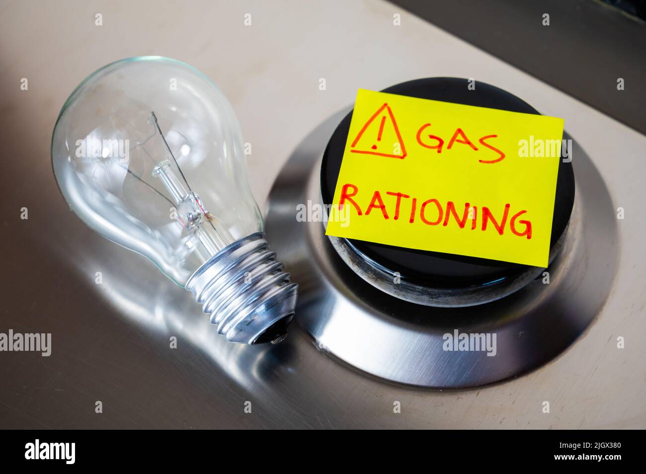 Gas stove, with yellow note next to it with text "gas rationing" and ...