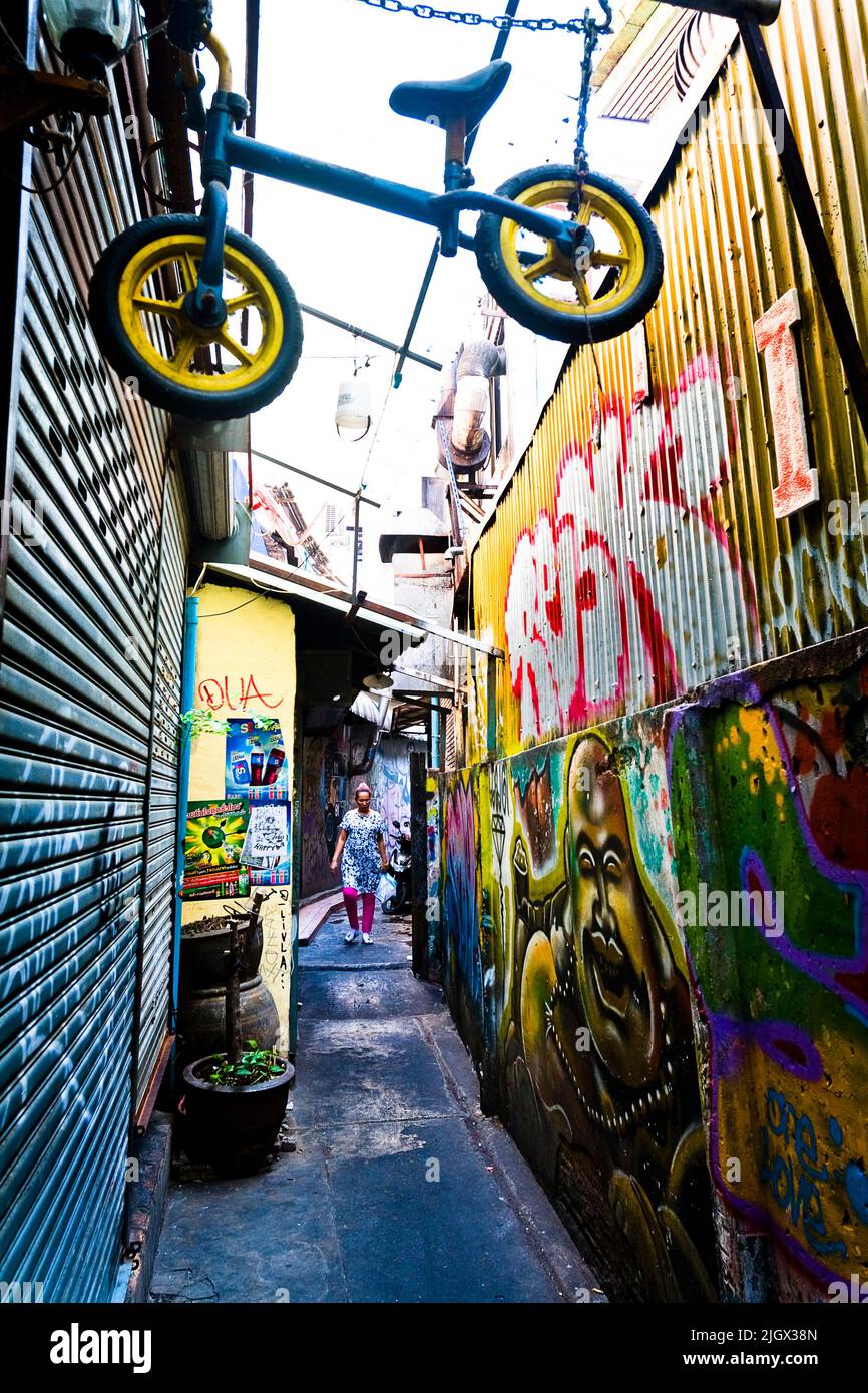 A Thai woman walking down a narrow alley in the Khao San area of ...