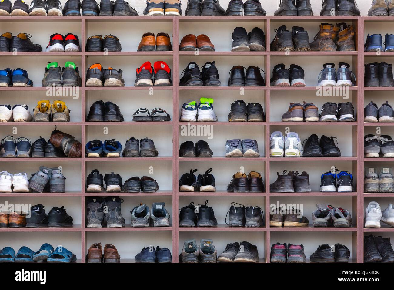 Shoes of people praying in front of the mosque, shoe rack Stock Photo ...