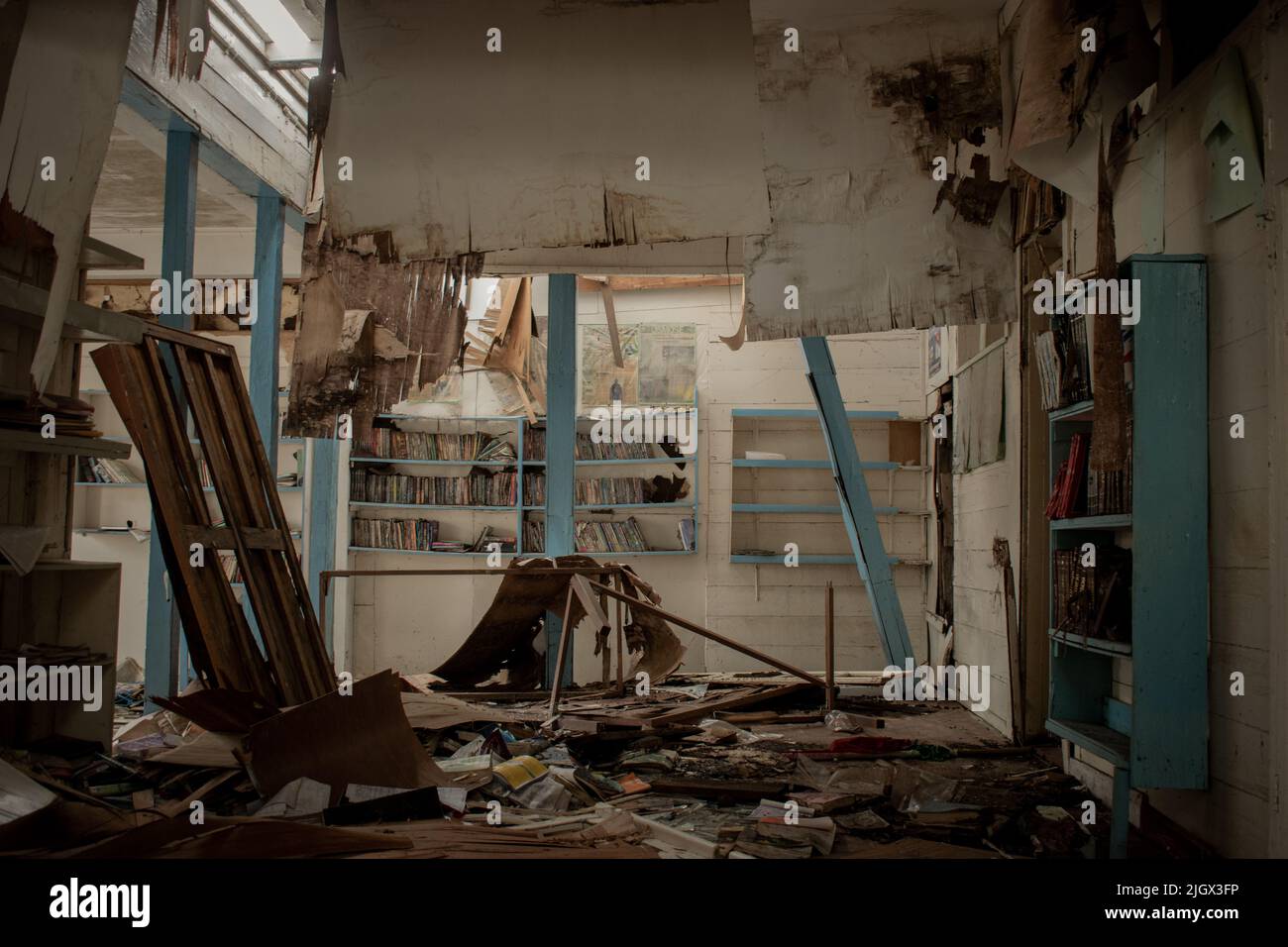 An Abandoned School with destroyed Wooden Interior and trashed shelves ...