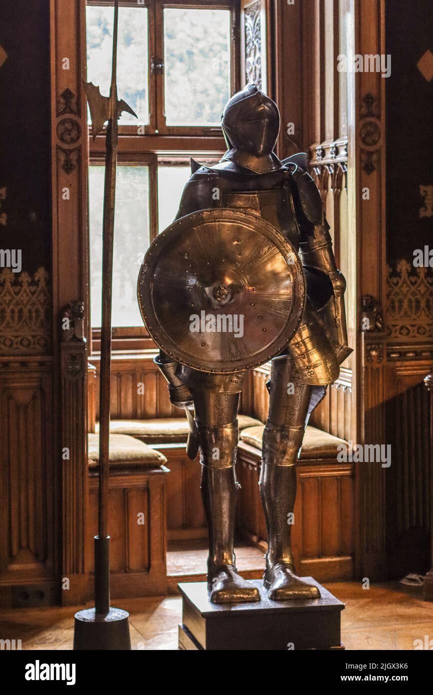 A vertical shot of a vintage metal knight armor inside Kasteel De Haar ...