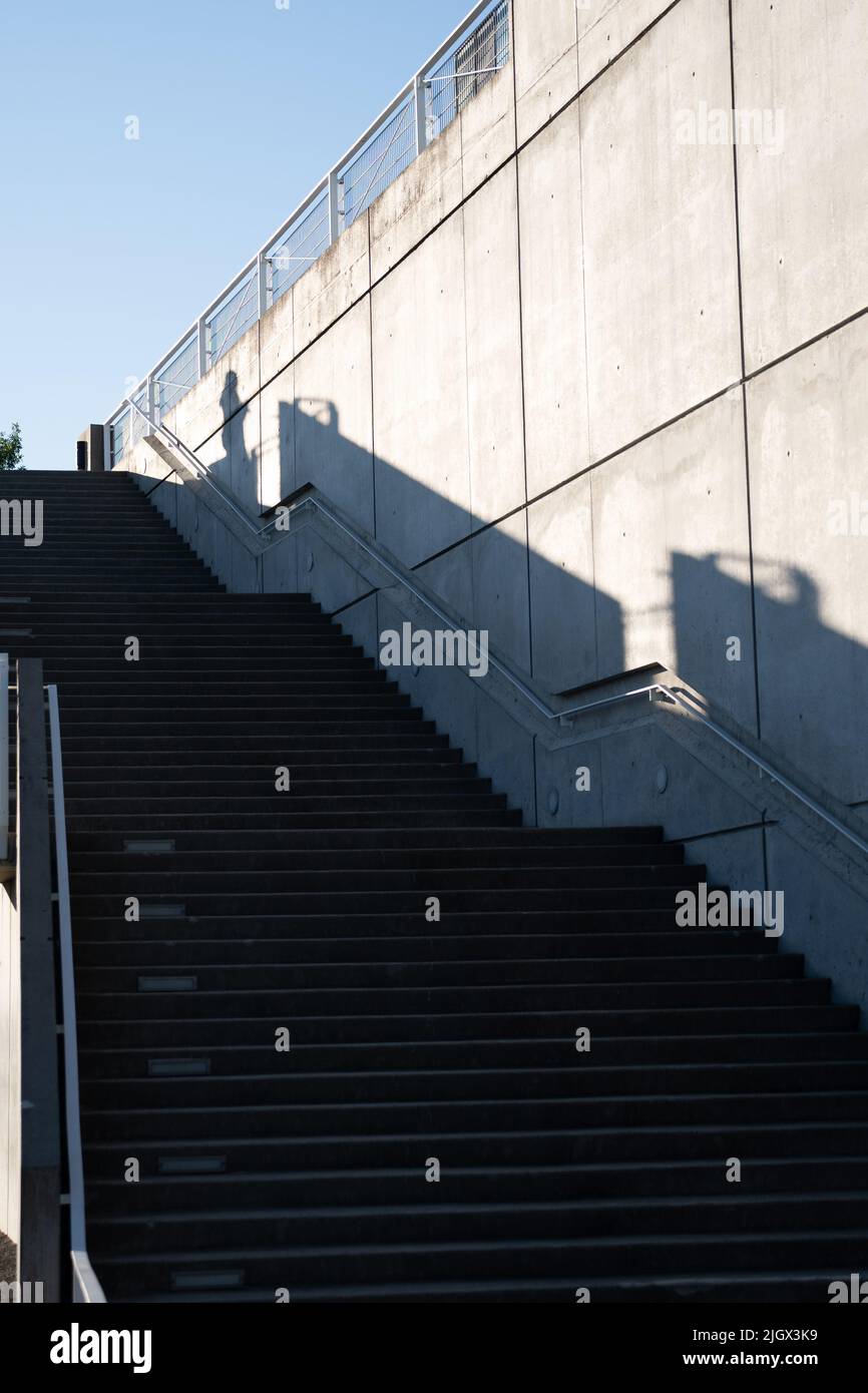 A vertical shot of long stairs by urban sunny walls in the street in ...