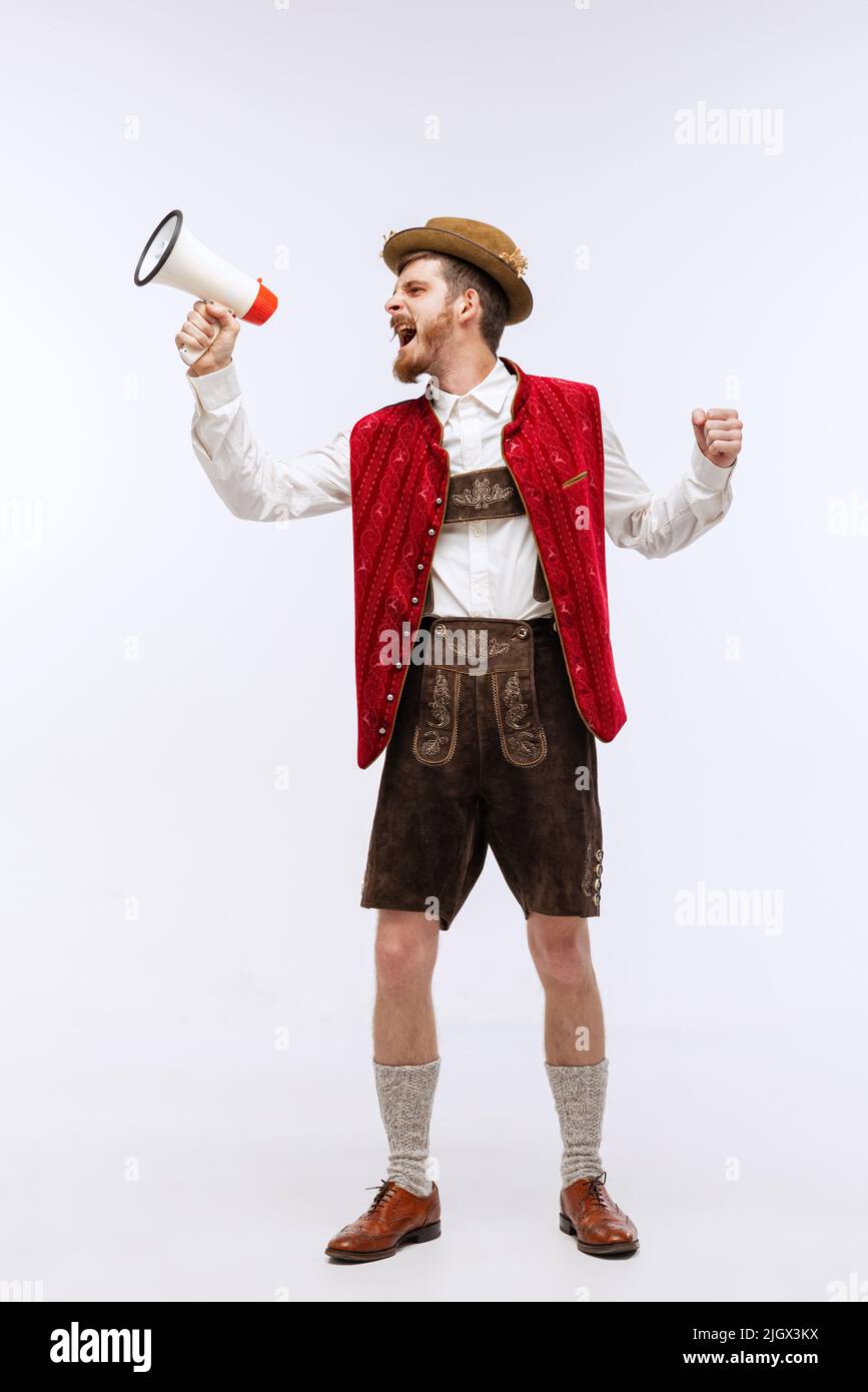 Excited man wearing traditional fest Bavarian or German outfit shouting ...
