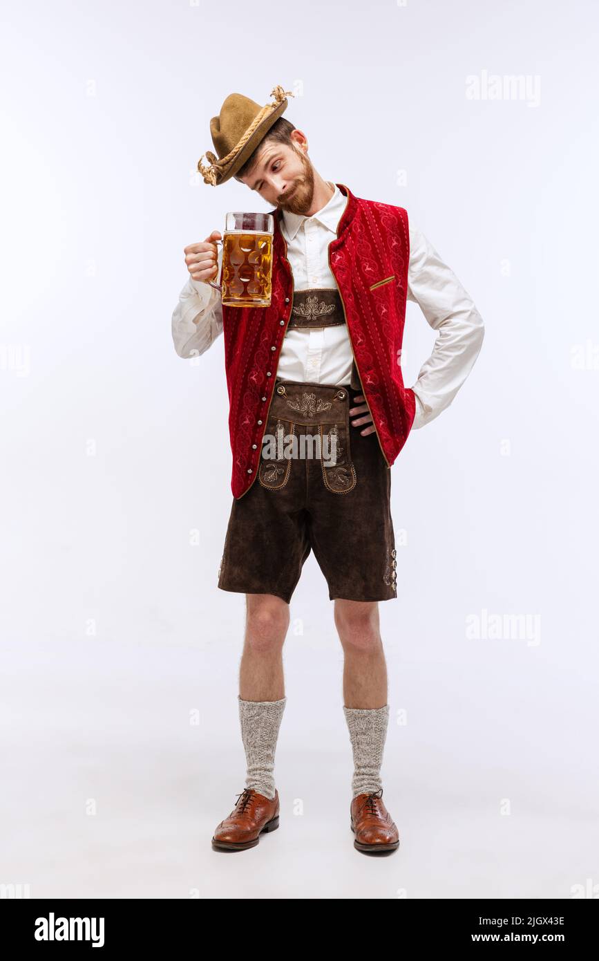 Funny man wearing traditional fest Bavarian or German outfit looking at ...