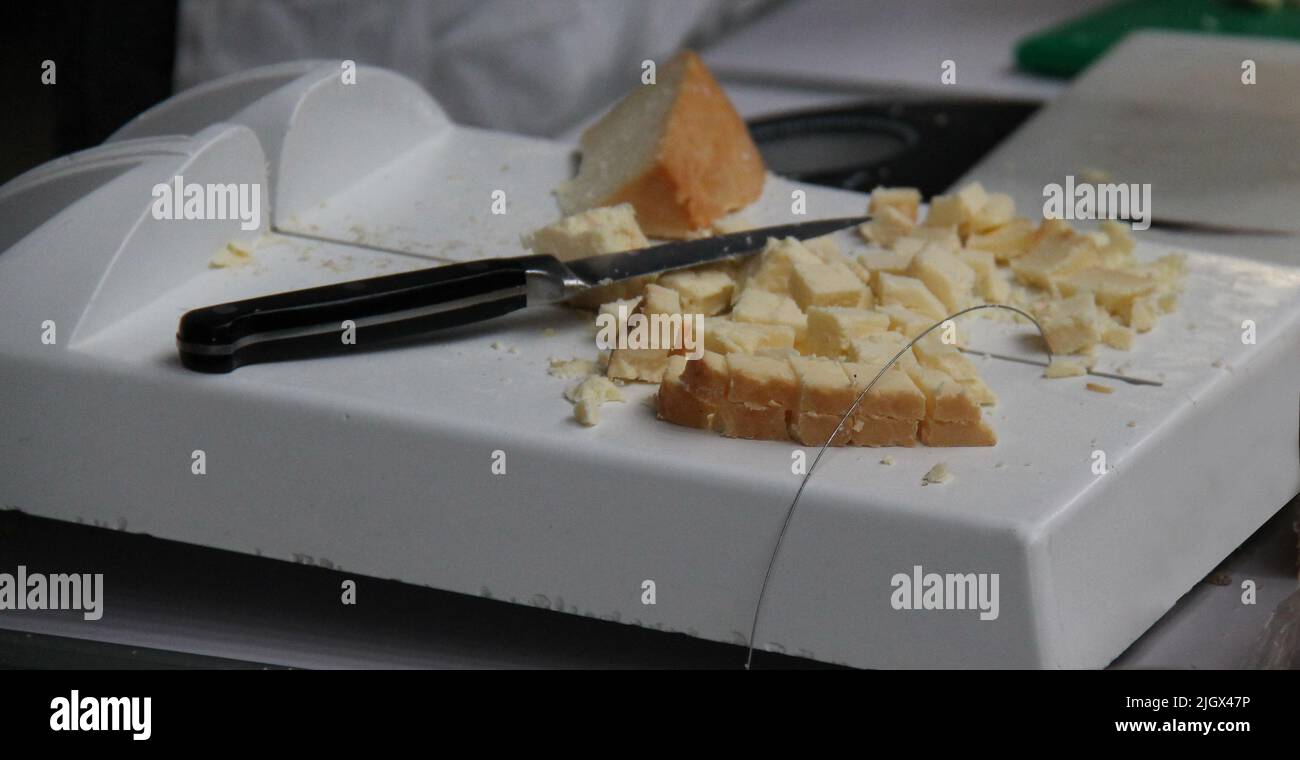 A Cheese Cutter with Small Samples Plus Knife and Bread Stock Photo - Alamy