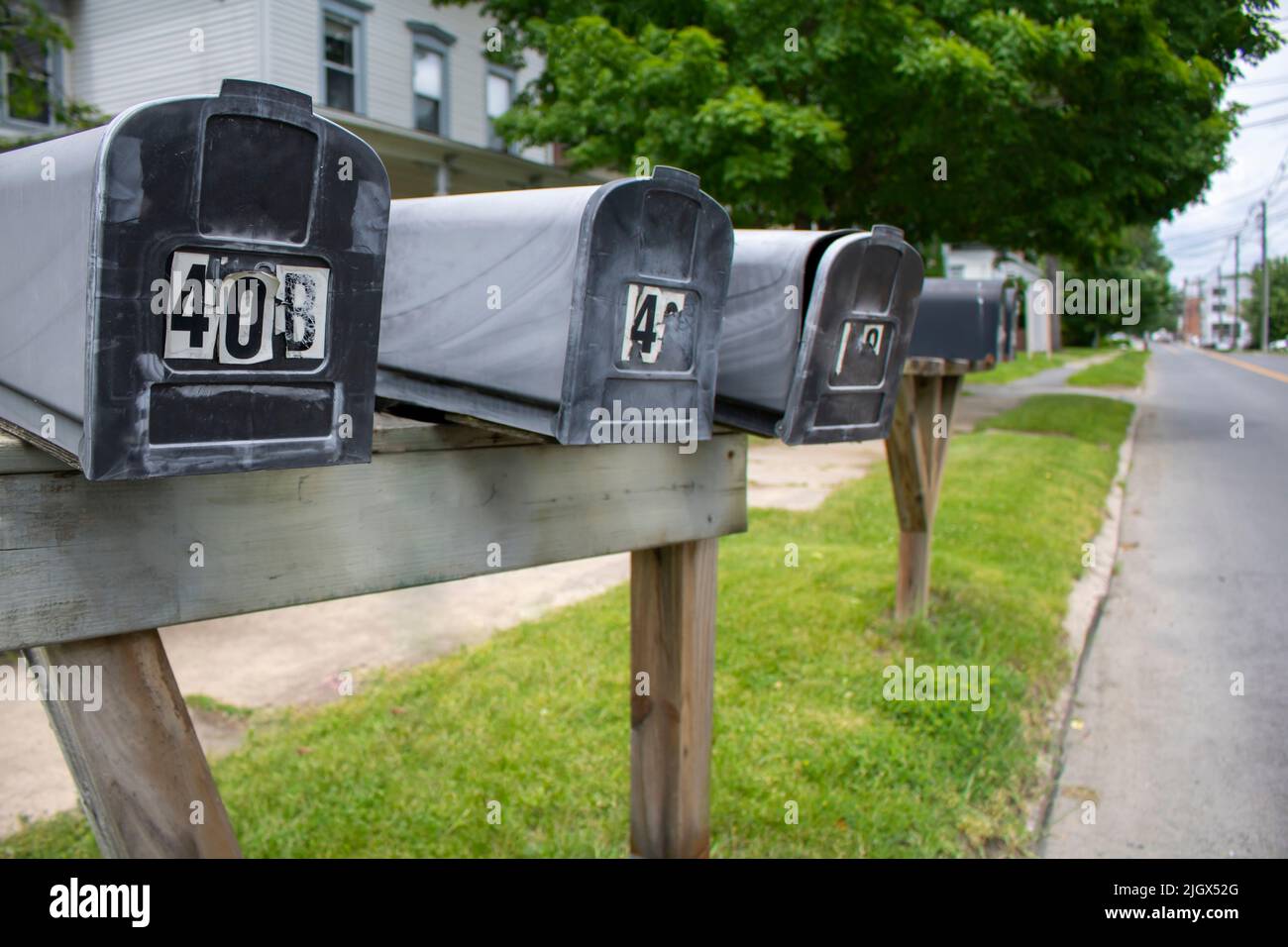 cluster line of street-side residential mailboxes in perspective Stock ...