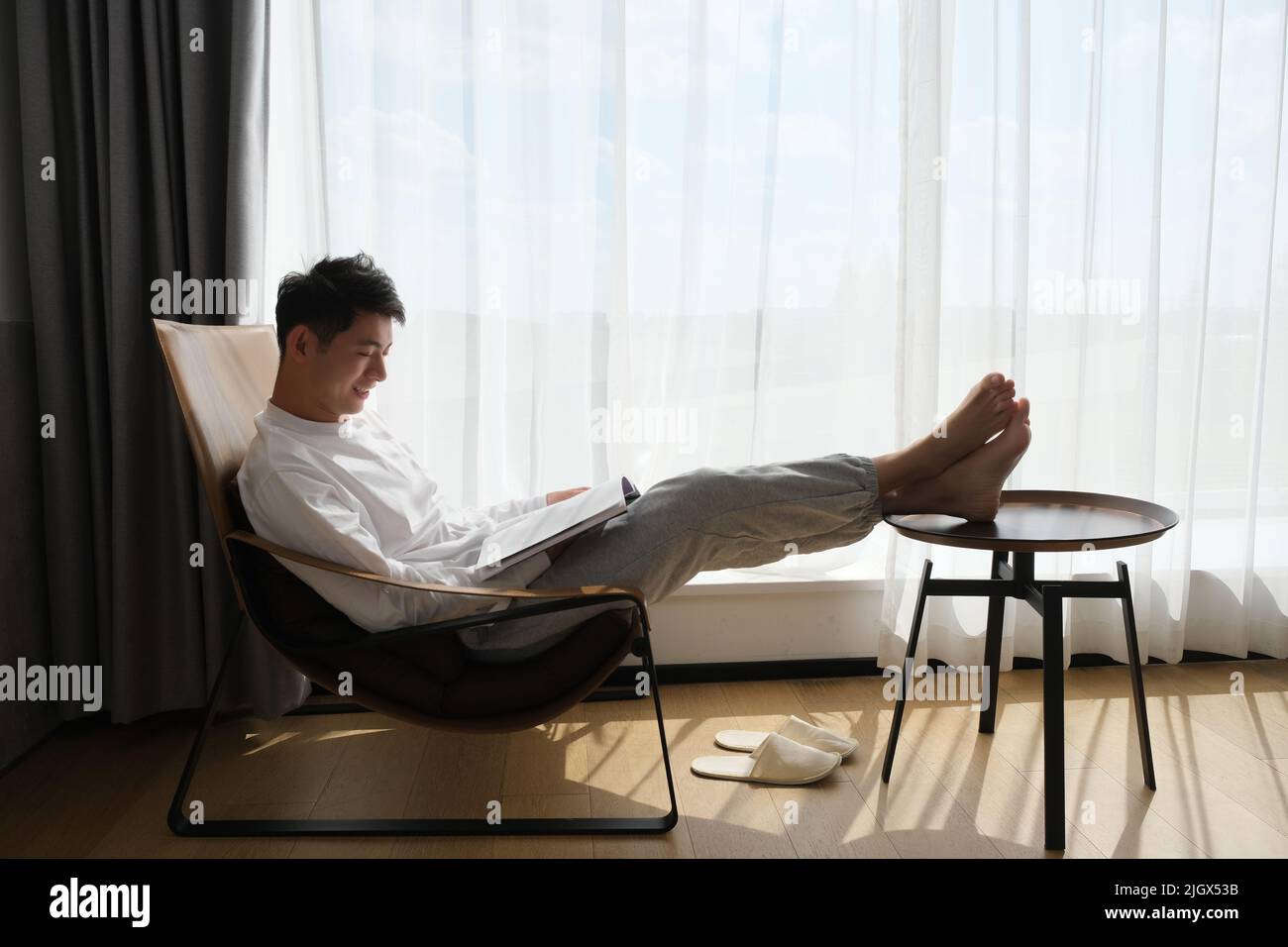 Man with book on chair hi-res stock photography and images - Alamy