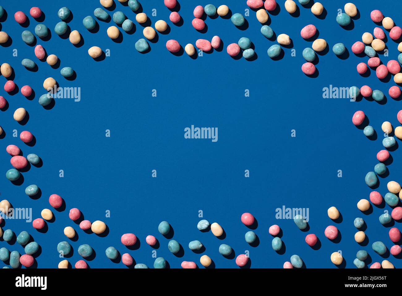 Photo of candies dragee placed on the perimeter of image with a copy ...