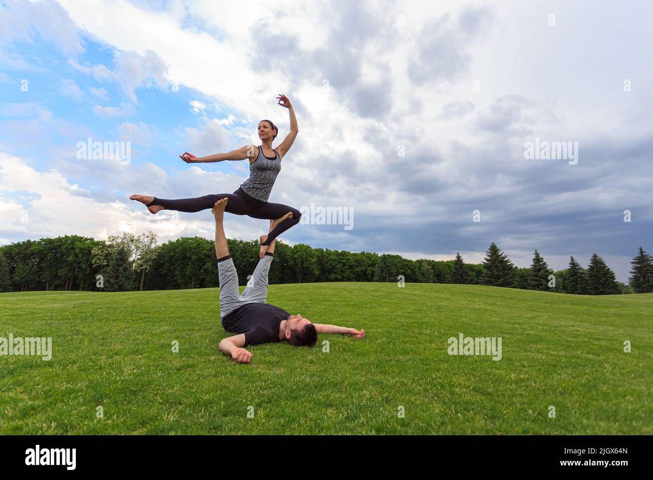 Strong acrobatic woman lifting man hi-res stock photography and images ...