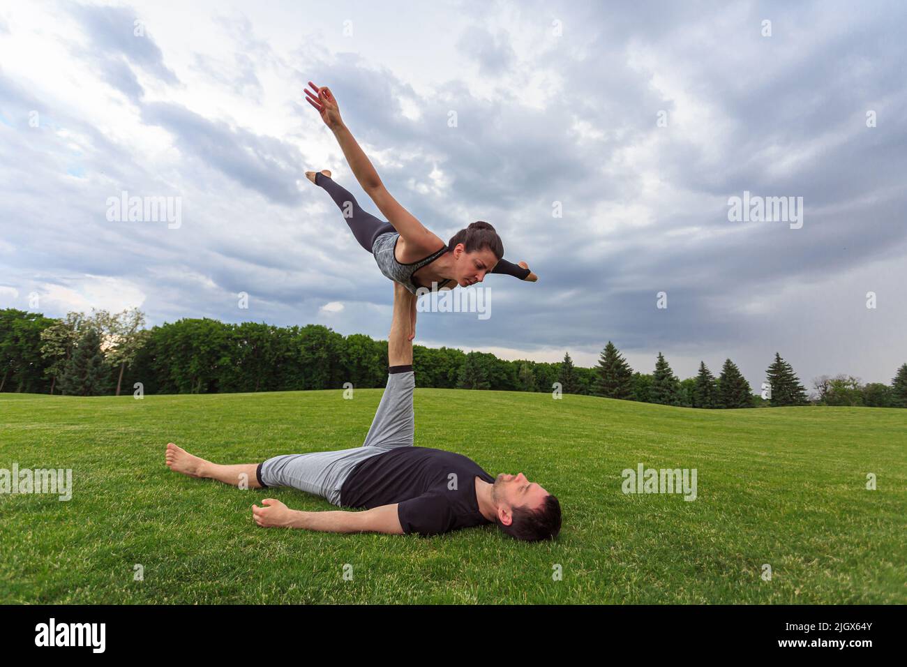 Strong acrobatic woman lifting man hi-res stock photography and images ...