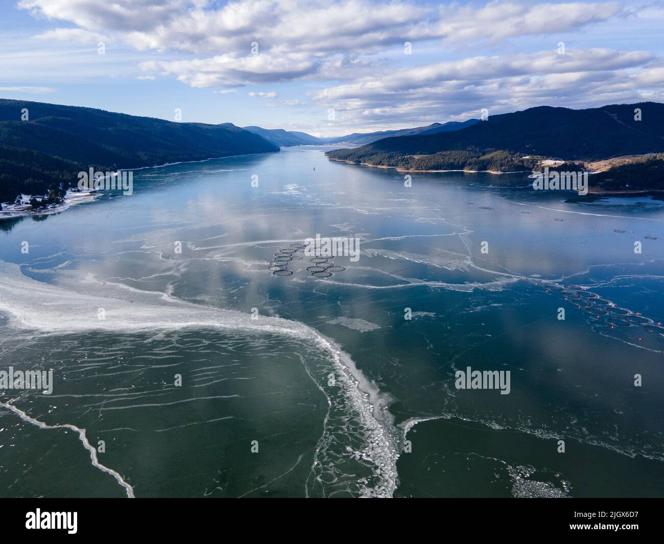 Aerial winter view of Dospat Reservoir covered with ice, Smolyan Region ...