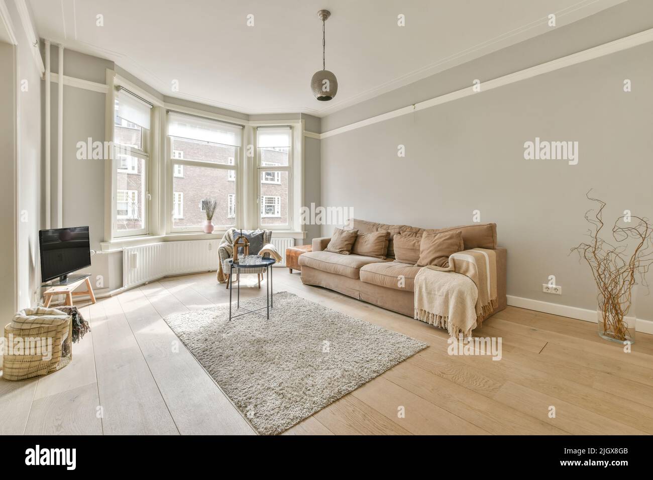 Table with chairs and comfortable sofa located in in spacious room with ...