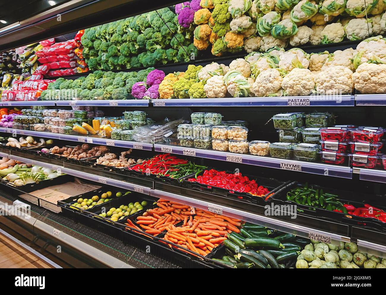 Fresh vegetable counter in supermarket. Fruits and vegetables on shop ...