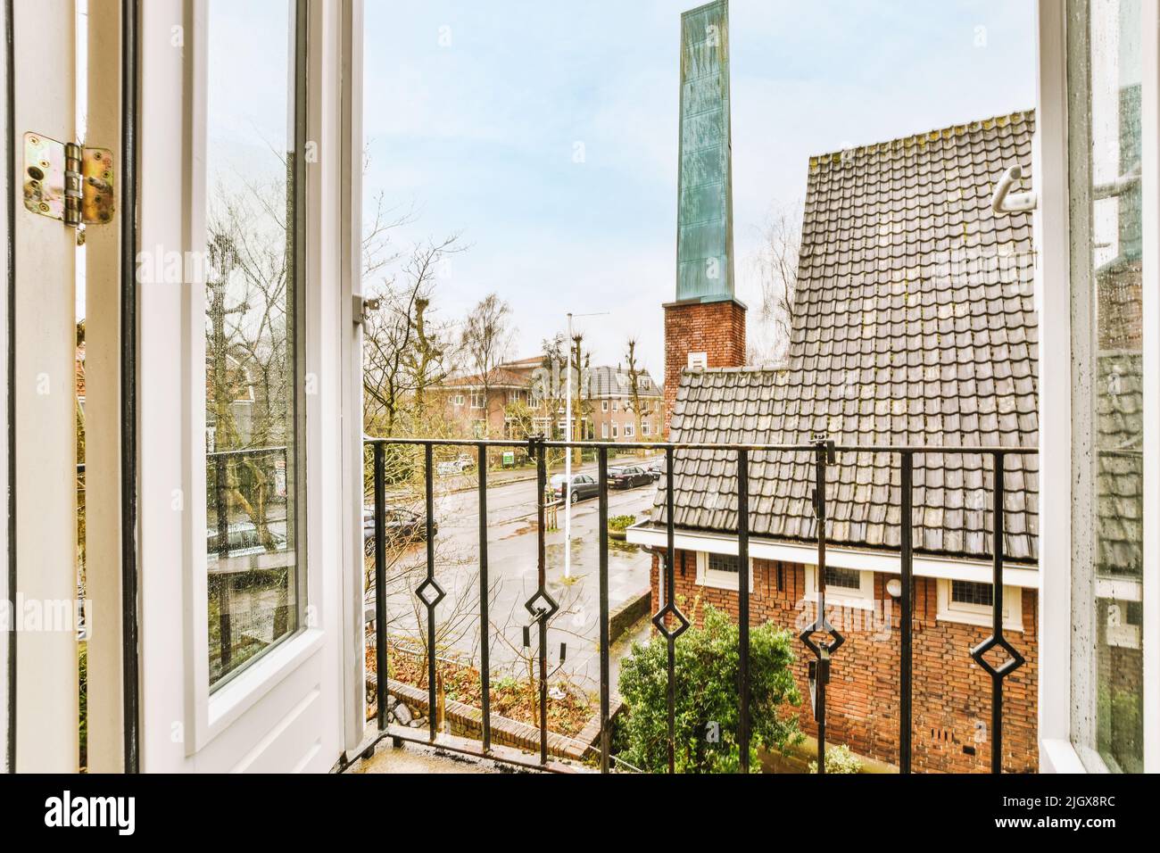 Narrow brick balcony with metal railings and door Stock Photo - Alamy