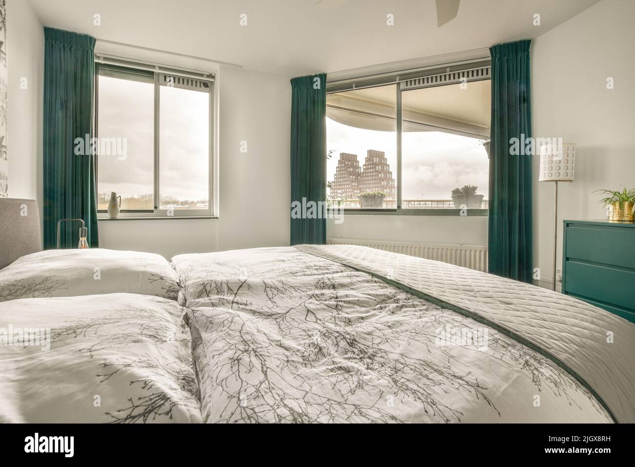 Home interior design of bedroom with bed and wooden wardrobe placed in ...