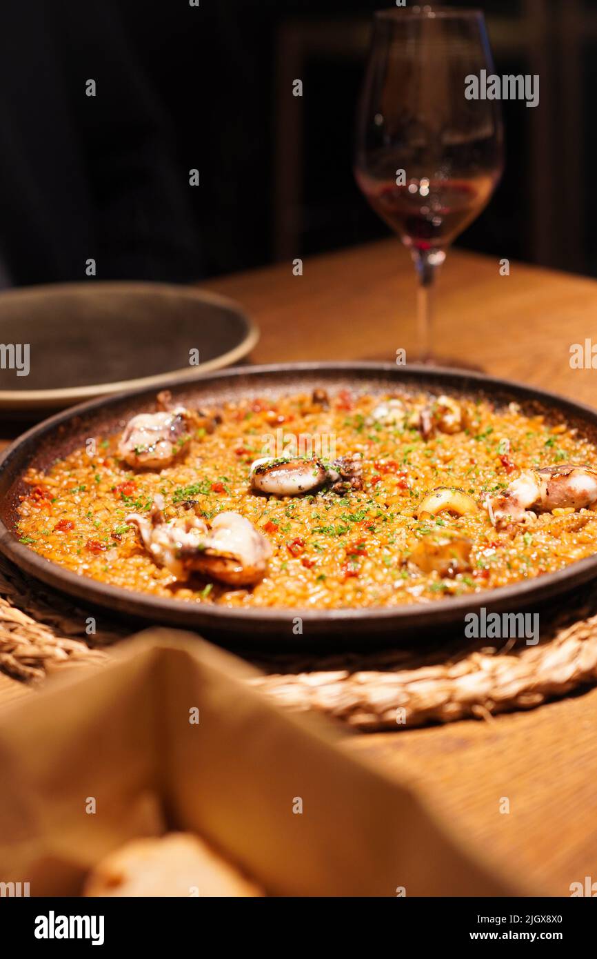 Paella with squid, Spanish traditional cuisine Stock Photo - Alamy